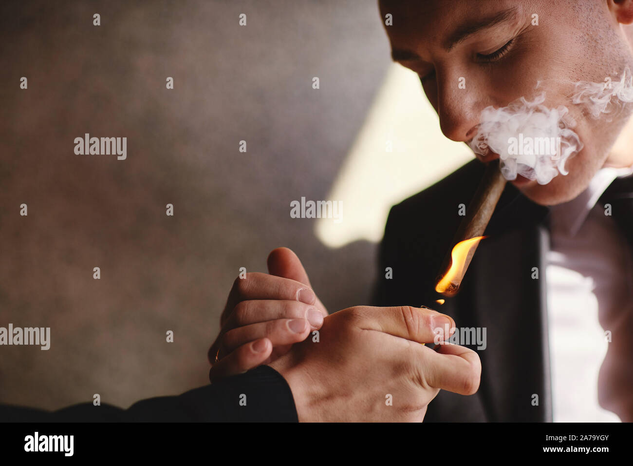 elegant man wearing suit and white shirt smoking cigar indoor shot ...