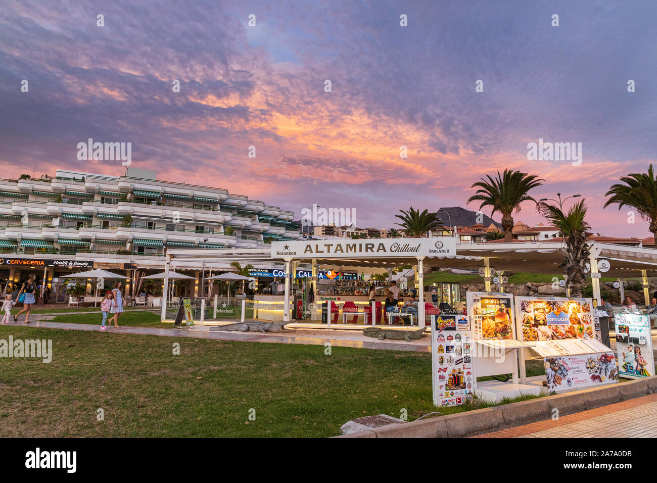 Hotels and restaurants along the front at sunset at Costa Adeje ...