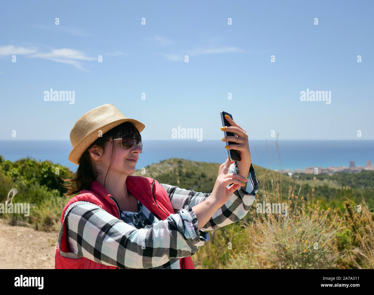 Smiling beautiful brunette taking selfie hi-res stock photography and ...