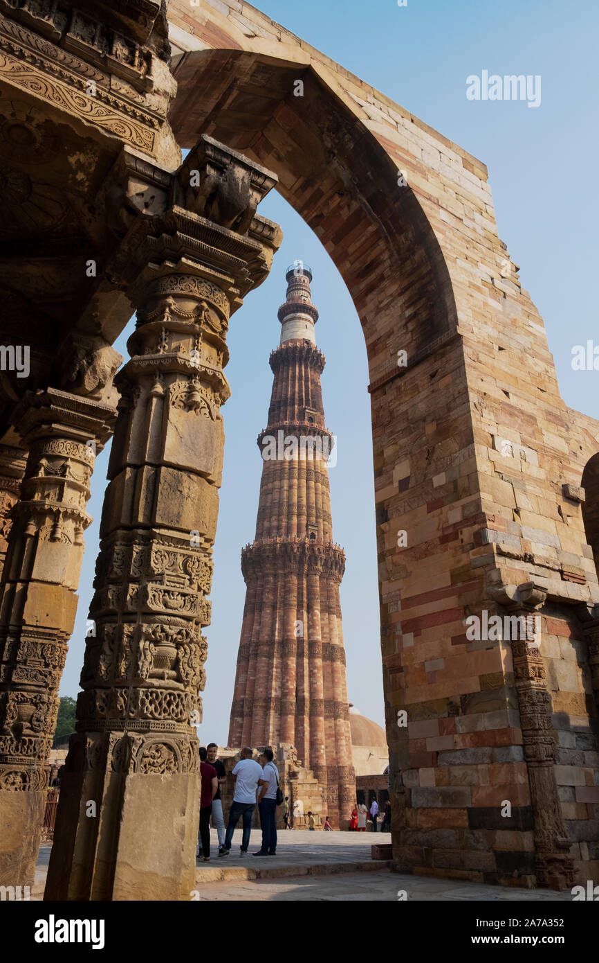 View of Qutub minar against the jain temple pillars and the screen arch ...