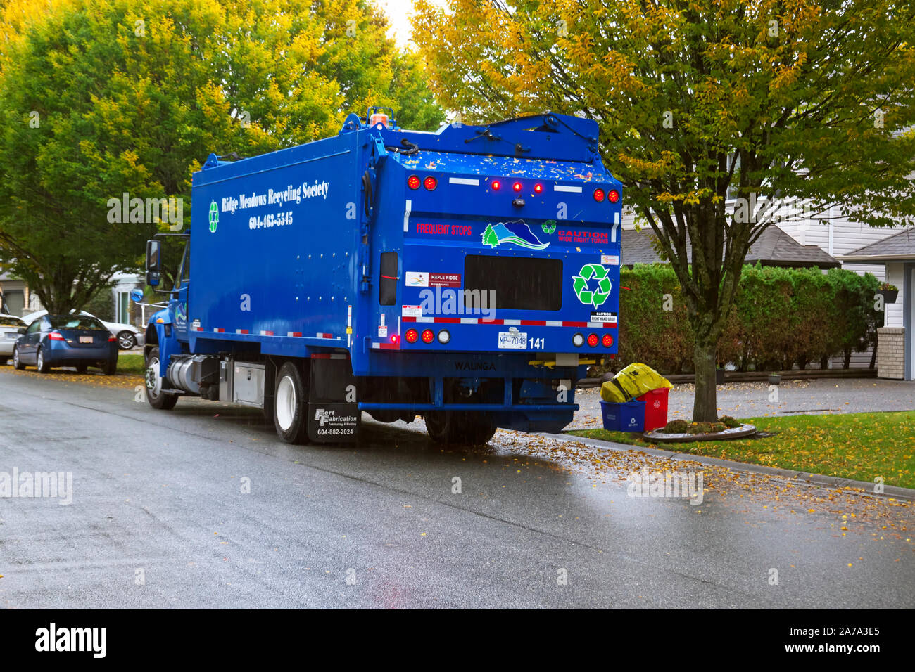 Back of a Blue Recycling Truck on a Residential Street in the Lower ...