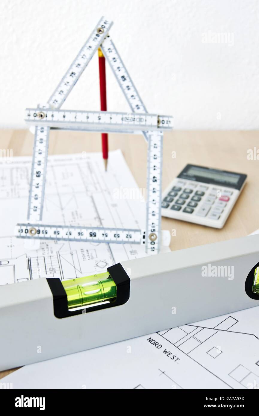 Construction plan with folding rule and water level Stock Photo - Alamy