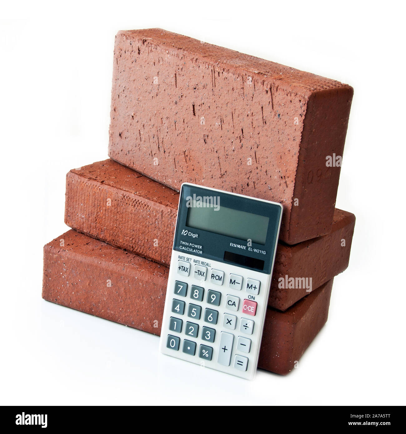 Red bricks and calculator on white background Stock Photo - Alamy