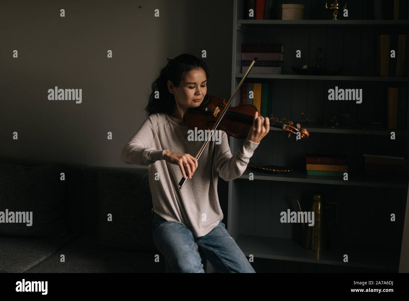 Beautiful young woman violinist plays the violin at home Stock Photo ...