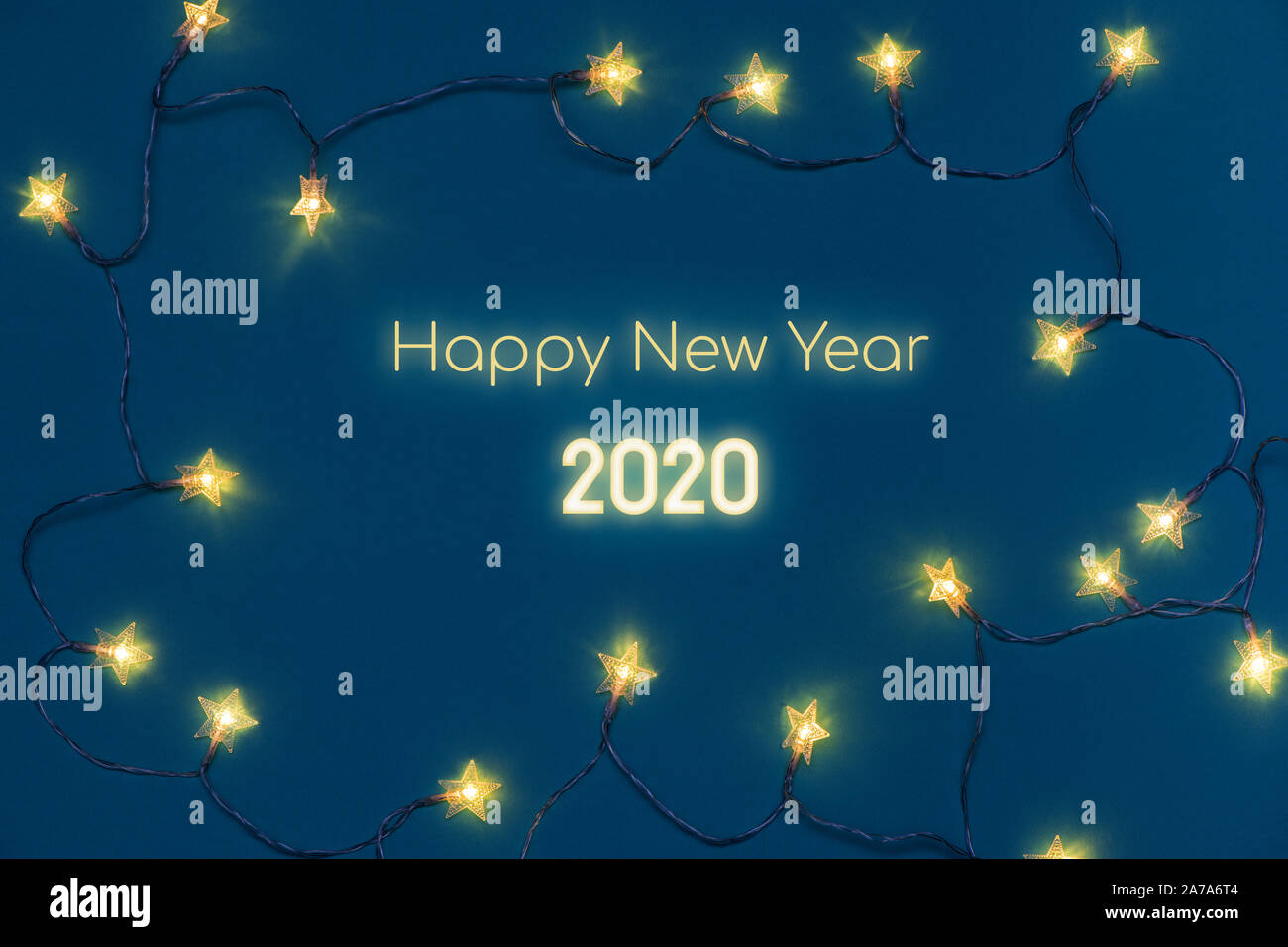 HAPPY NEW YEAR 2020 neon text in electric garland frame on blue ...