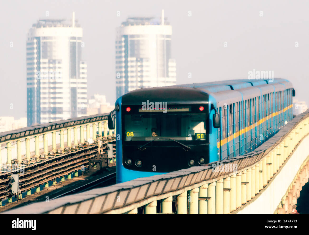 blue modern metro cars on the background of office skyscrapers in Kiev ...