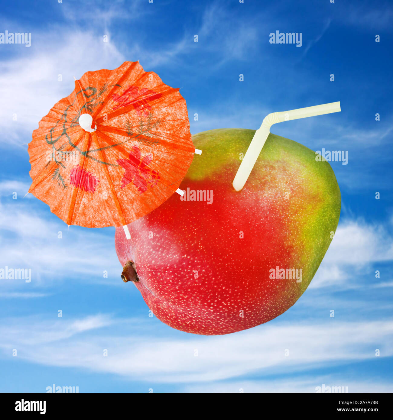 Mango with straw on sky background Stock Photo - Alamy