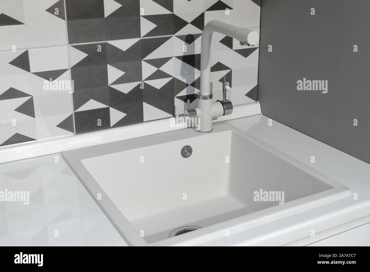 modern white square sink with long tap located on smooth white kitchen ...
