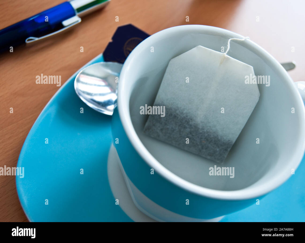 Break tea bag in cup with wooden background Stock Photo - Alamy