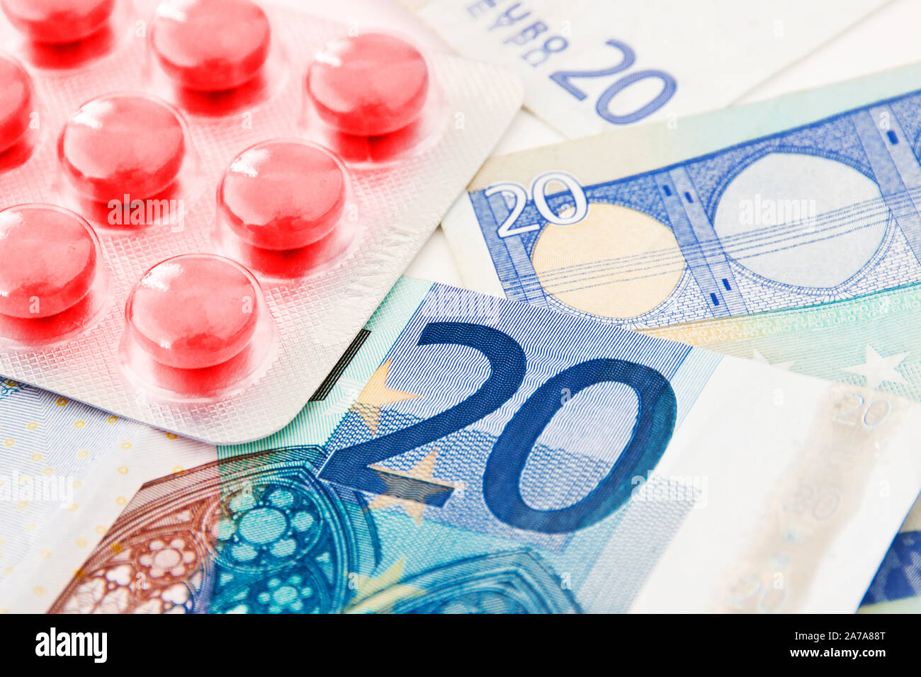 Red tablets and twenty euro notes background Stock Photo - Alamy