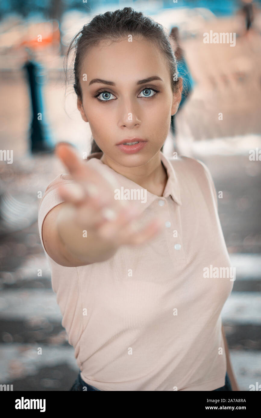 Beautiful girl holds out her hand Stock Photo - Alamy