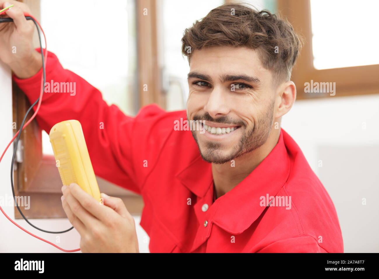 man measures the voltage at the terminals Stock Photo - Alamy