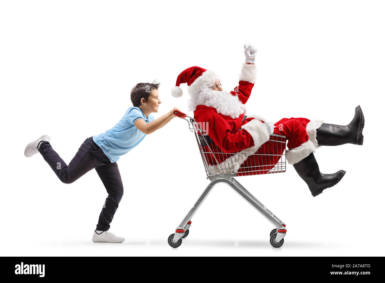 Full length profile shot of a boy pushing Santa Claus in a shopping ...