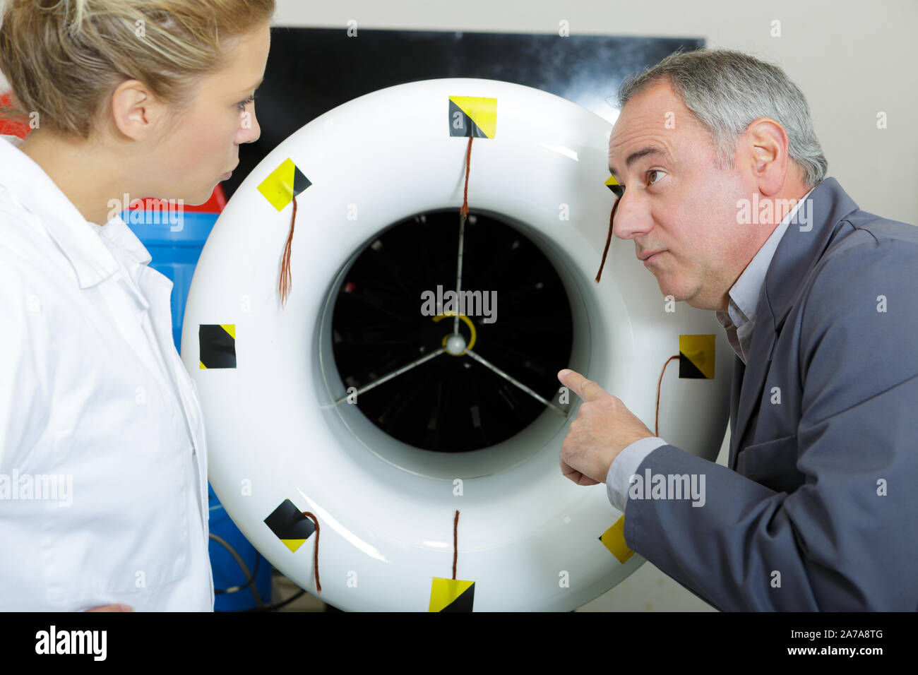 instructor explaining to a colleague how the machine works Stock Photo ...