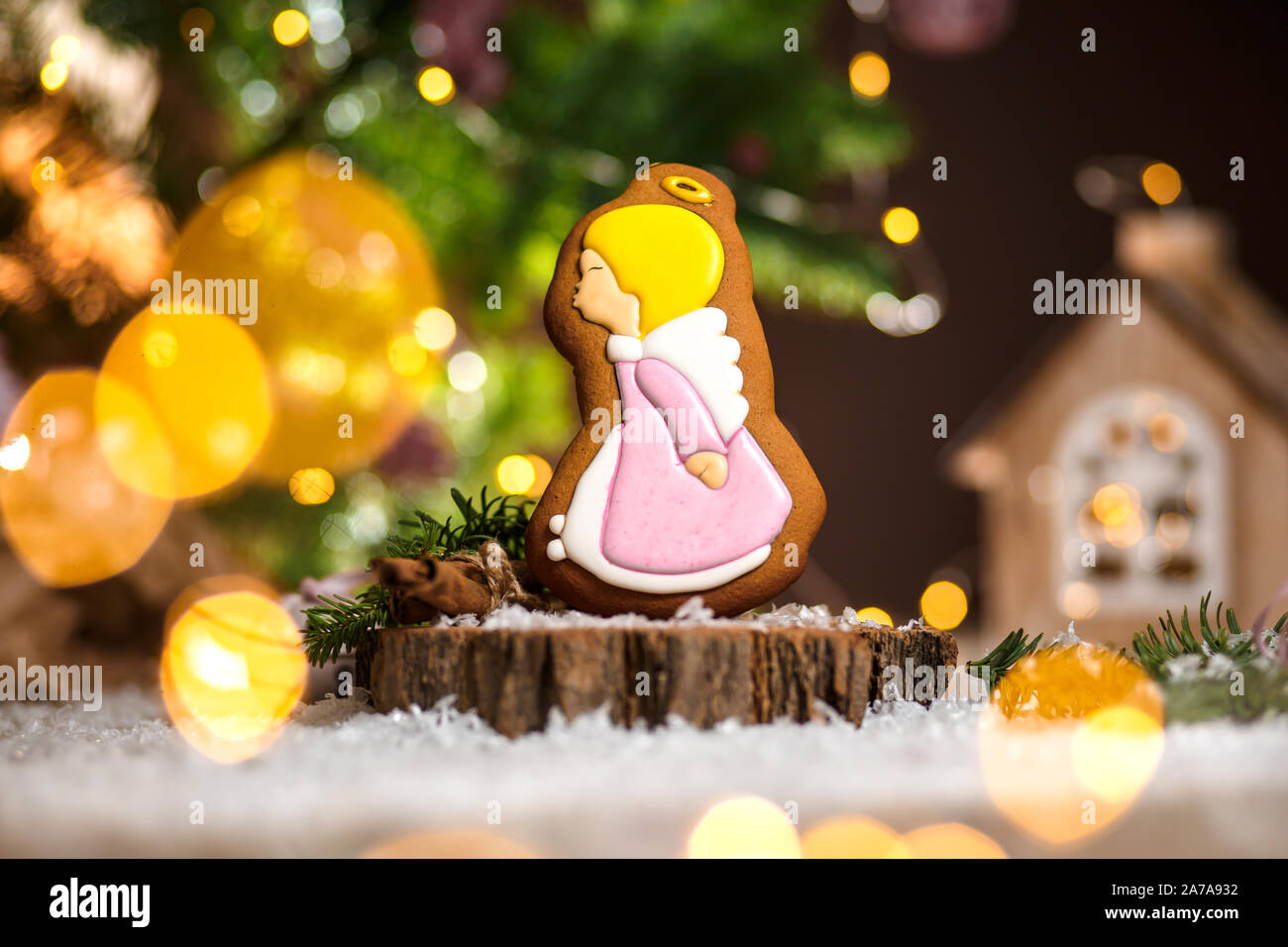 Holiday traditional food bakery. Gingerbread cute angel girl in cozy ...