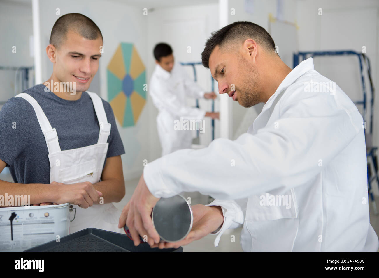a painter with an apprentice Stock Photo - Alamy
