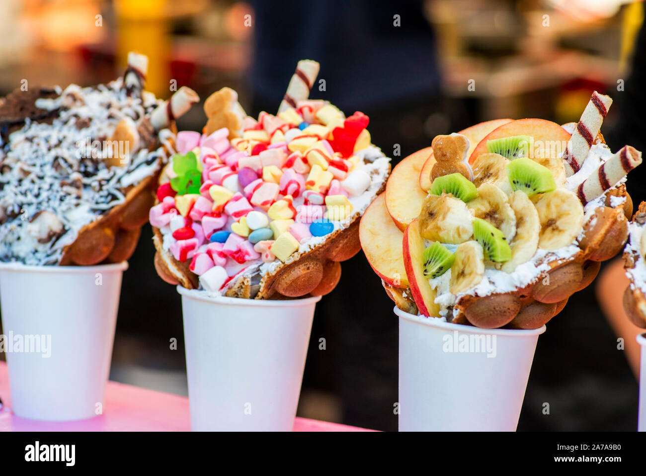Bubble waffles with raspberries, chocolate and marshmallow in white ...