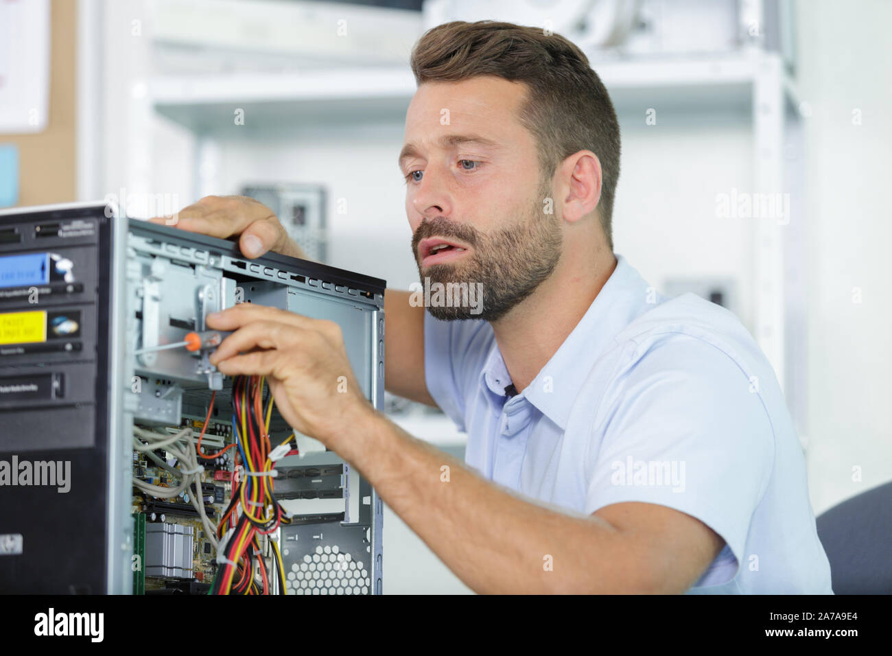 male worker fixing a computer plugin Stock Photo - Alamy
