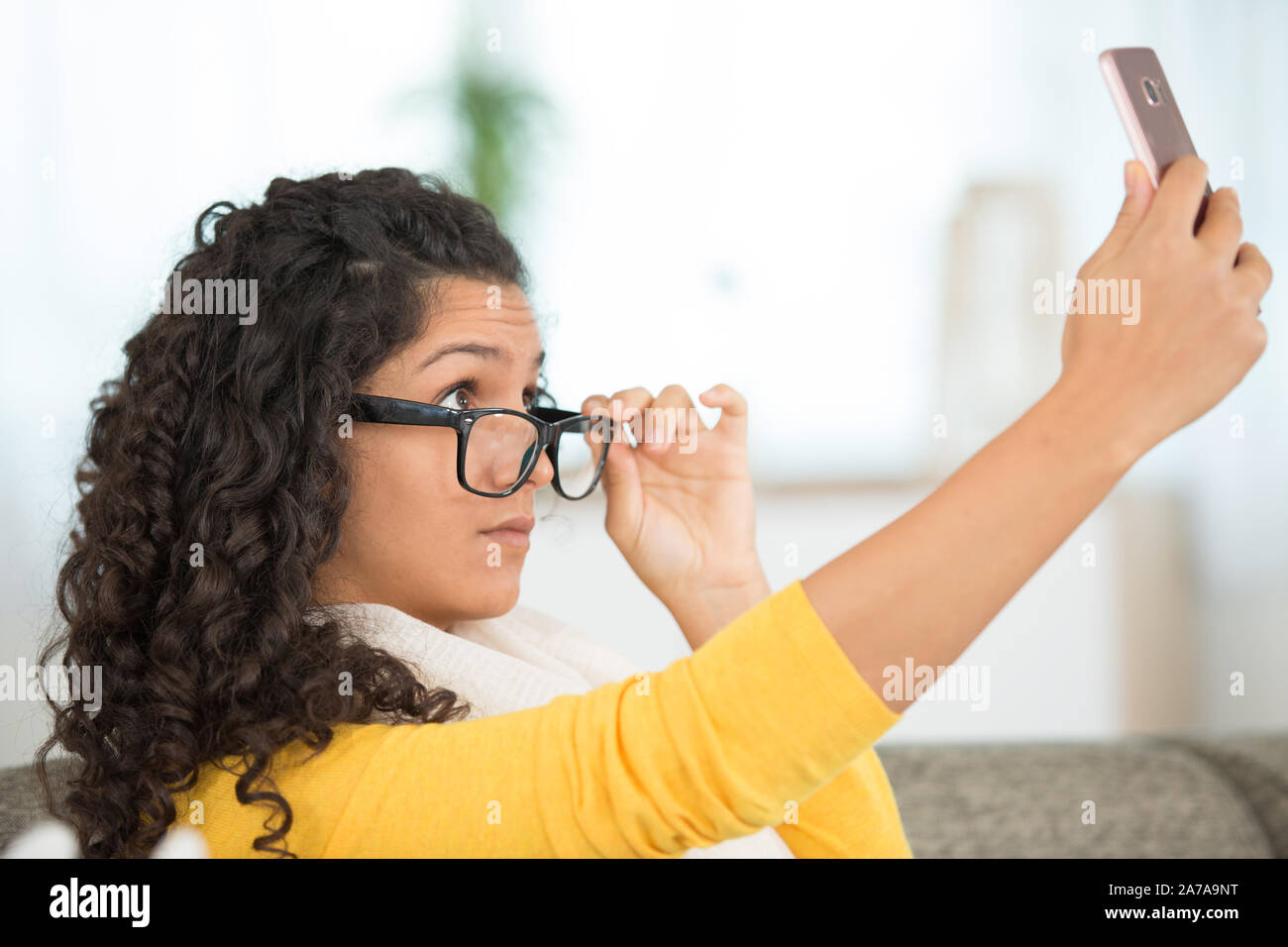 lady lowering her eyeglasses to take a selfie Stock Photo - Alamy
