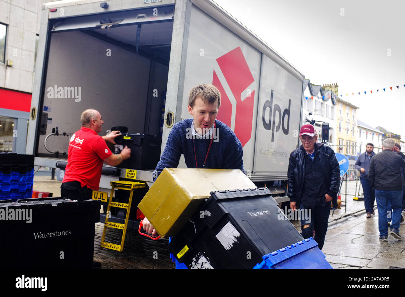 A DPD delivery van being unloaded and delivering Plastic boxes to a ...
