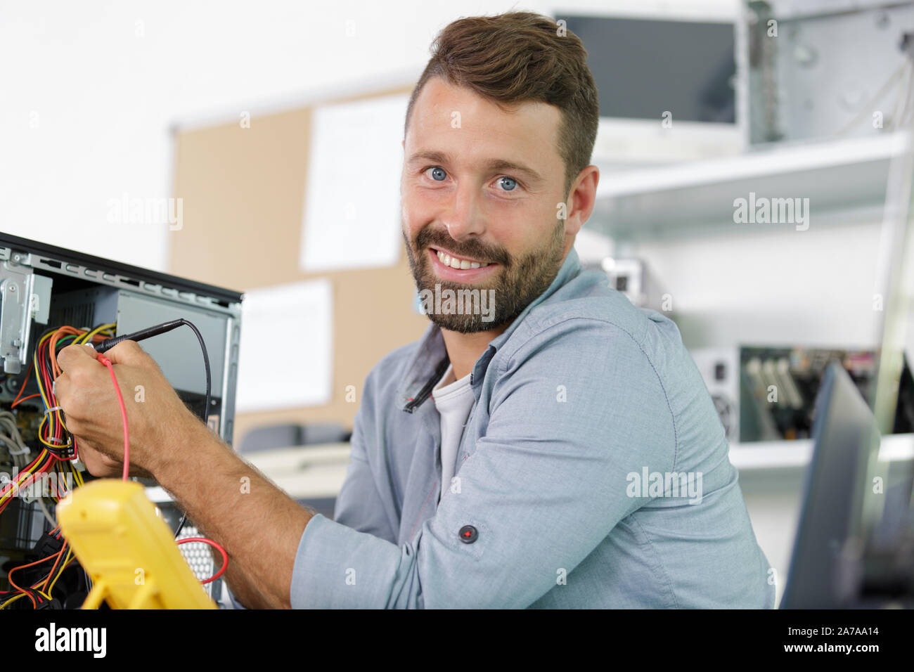 technician using voltage meter for voltage measurement in computer ...