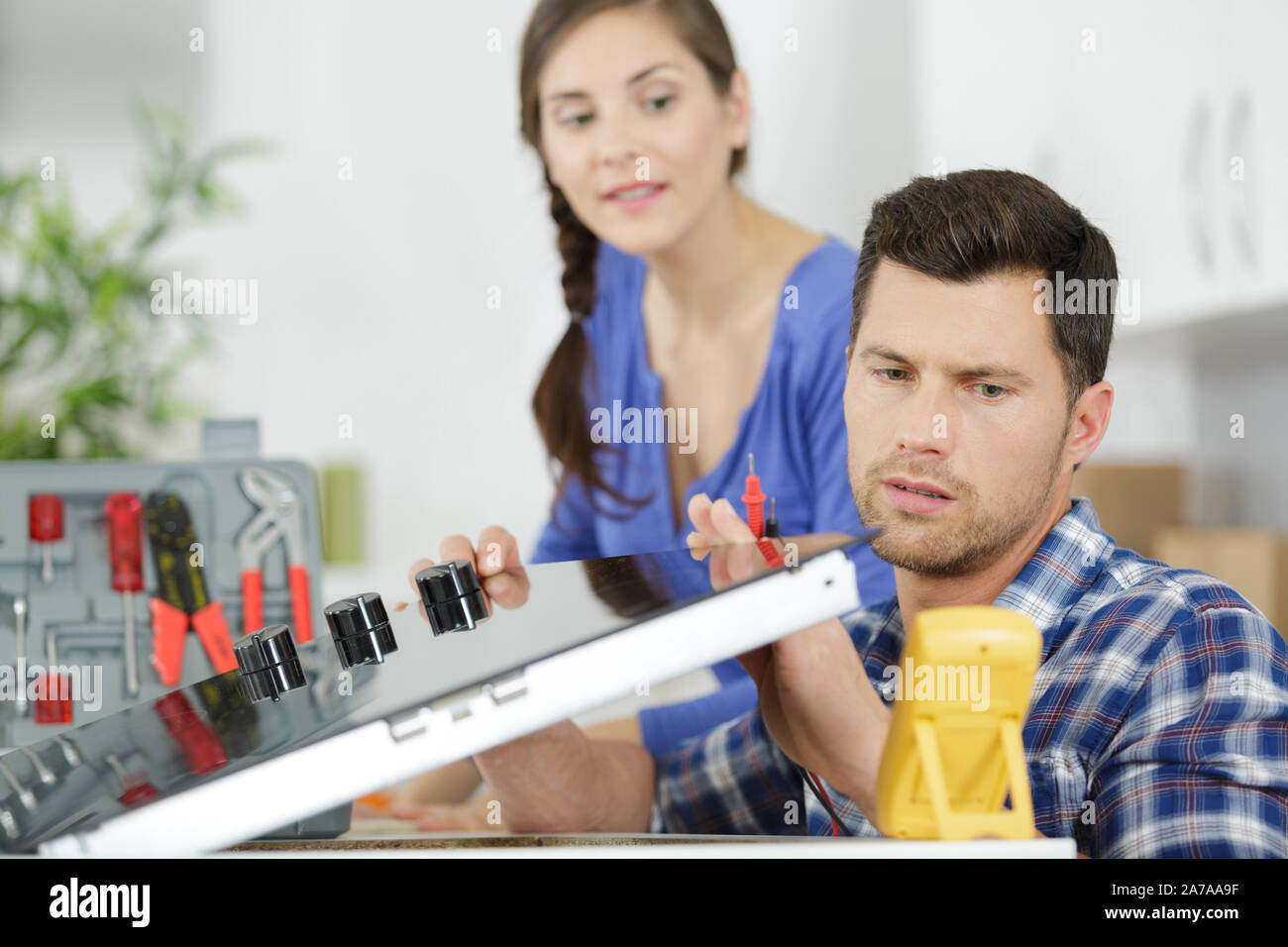a repair service man with female customer Stock Photo - Alamy