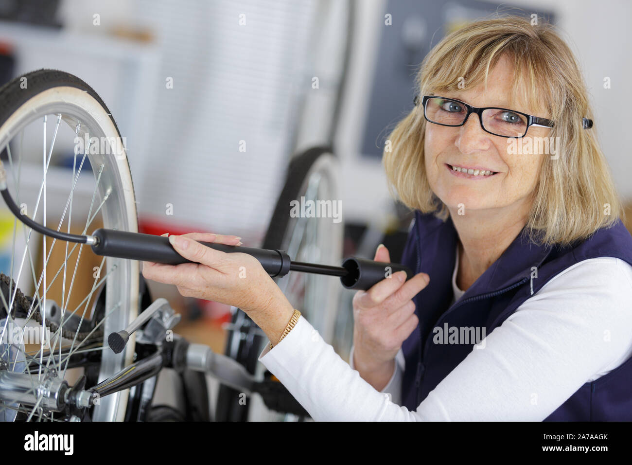 Mechanic examining bicycle wheel hi-res stock photography and images - Alamy