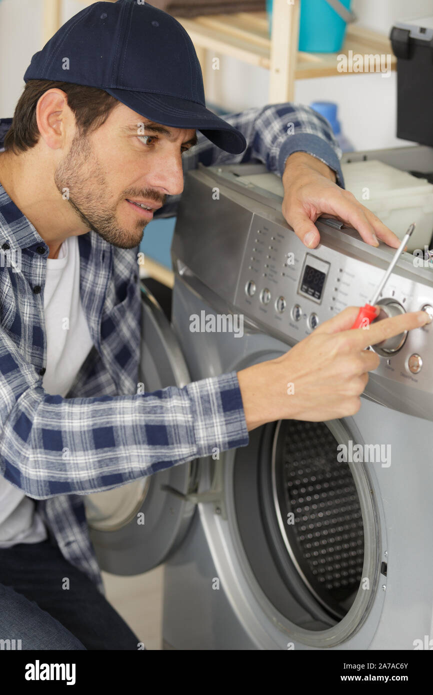 Technician repairing washing machine hi-res stock photography and ...