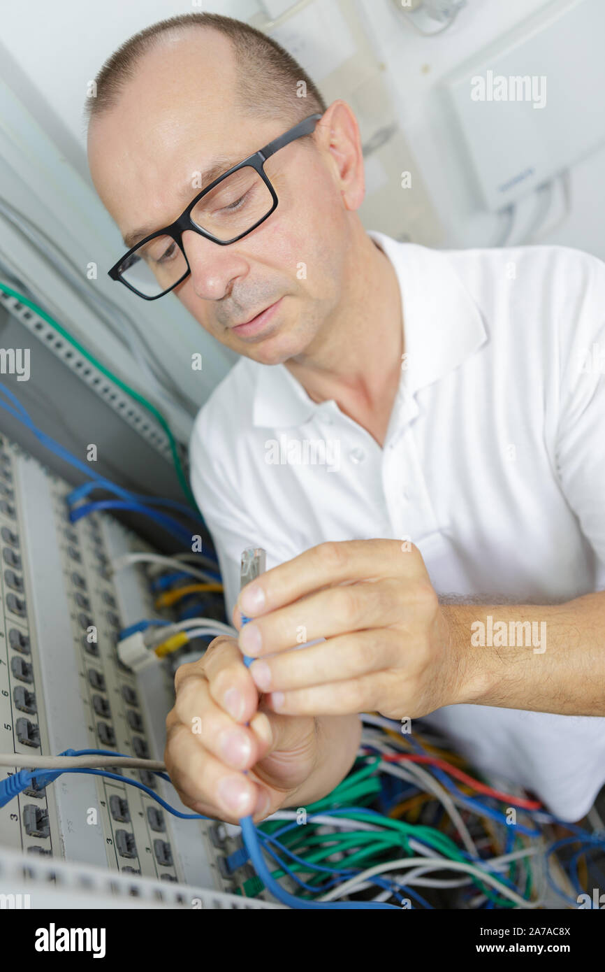 network engineer working in server room Stock Photo - Alamy