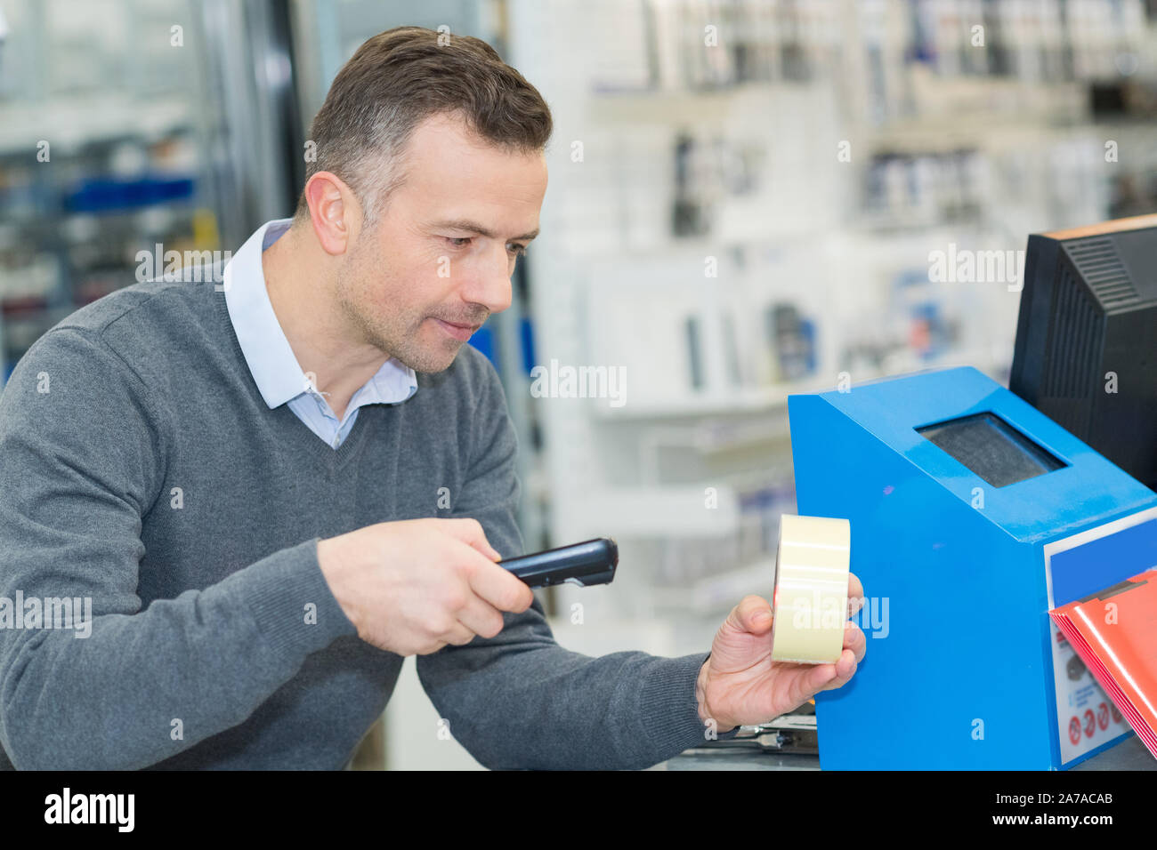 man is scanning a product in a warehouse Stock Photo - Alamy
