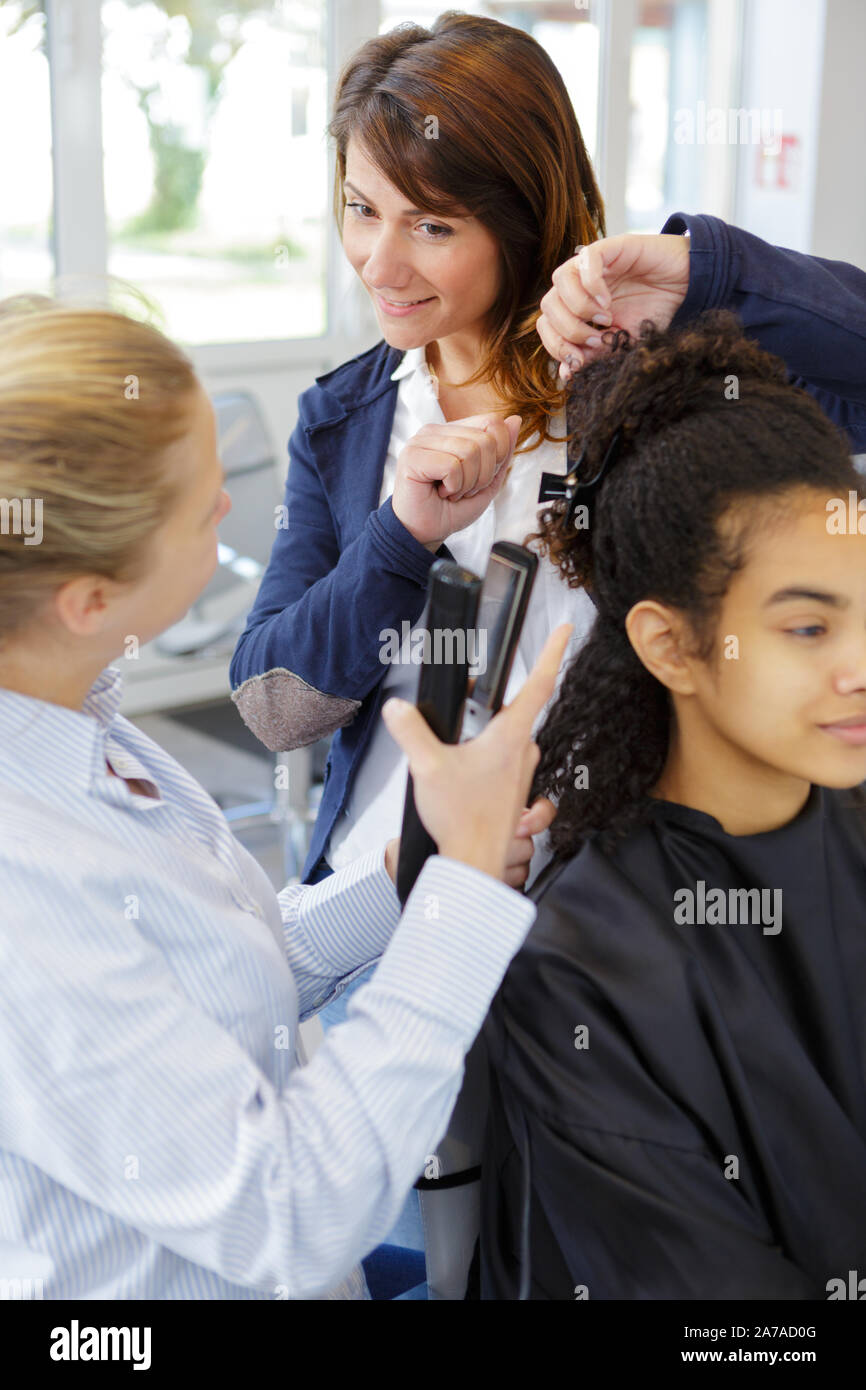 teacher talking to students while hairdresser test Stock Photo - Alamy