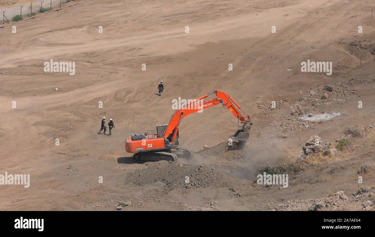 Enginers of 4M defense use an armored excavator with tillers and ...