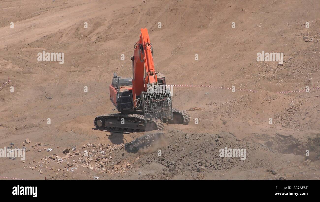 Enginers of 4M defense use an armored excavator with tillers and ...