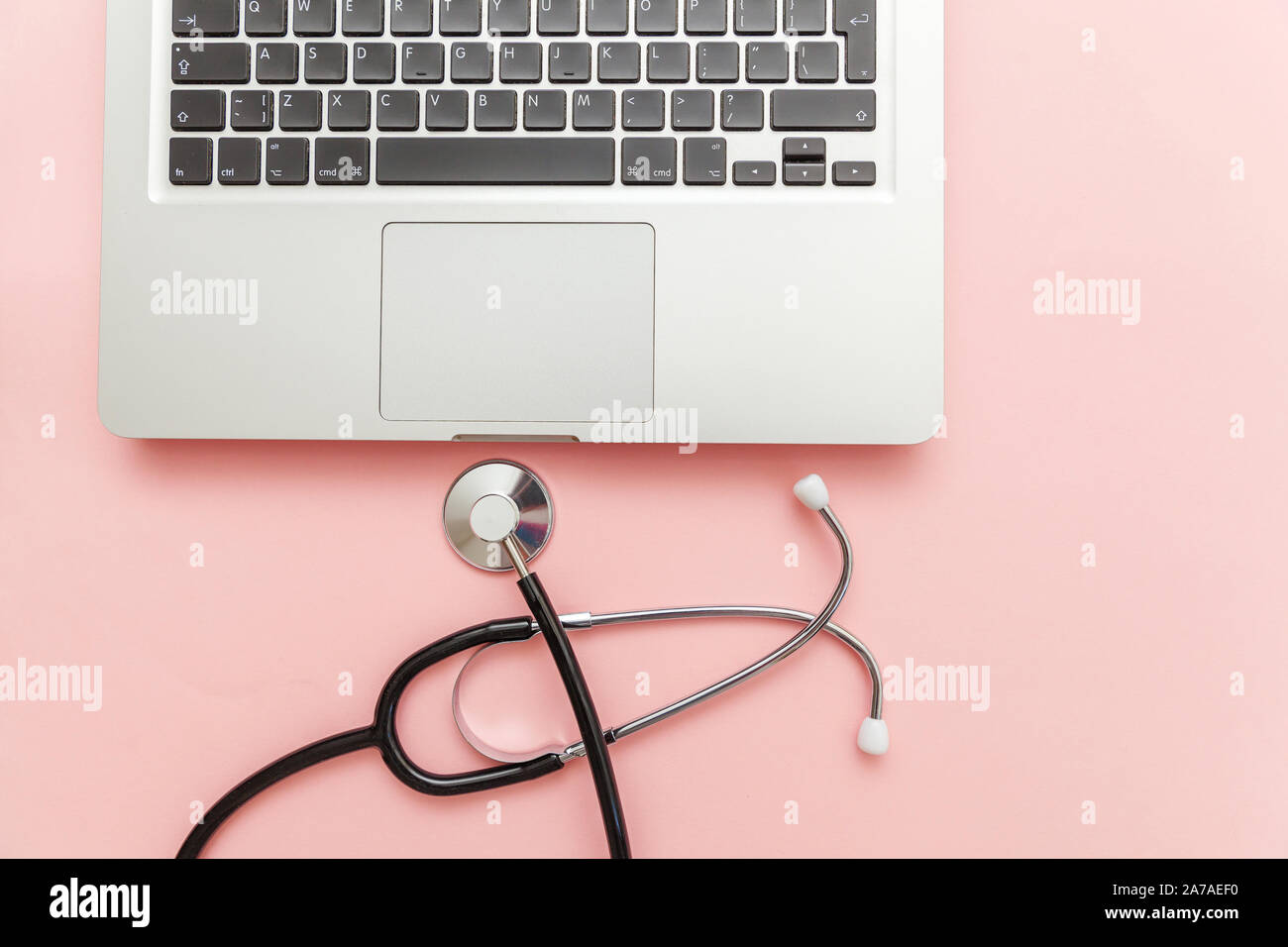 Stethoscope keyboard laptop computer isolated on pink background ...