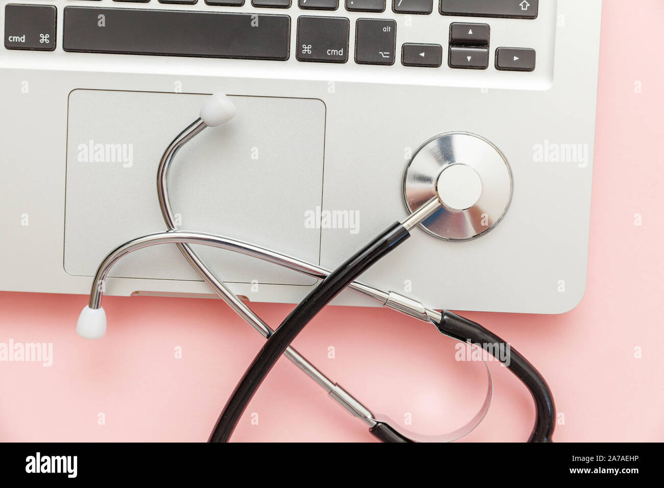 Stethoscope keyboard laptop computer isolated on pink background ...
