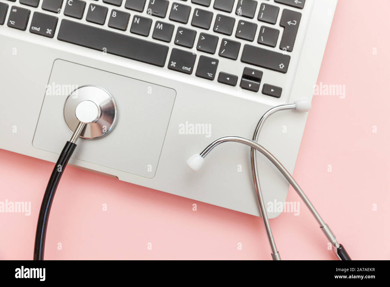 Stethoscope keyboard laptop computer isolated on pink background ...