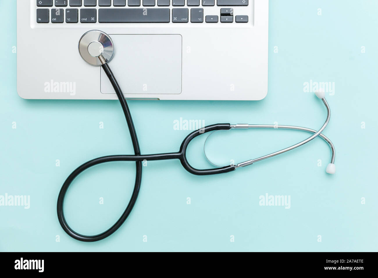 Stethoscope keyboard laptop computer isolated on blue background ...