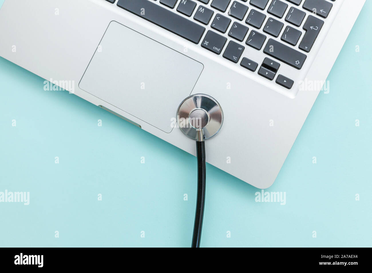 Stethoscope keyboard laptop computer isolated on blue background ...