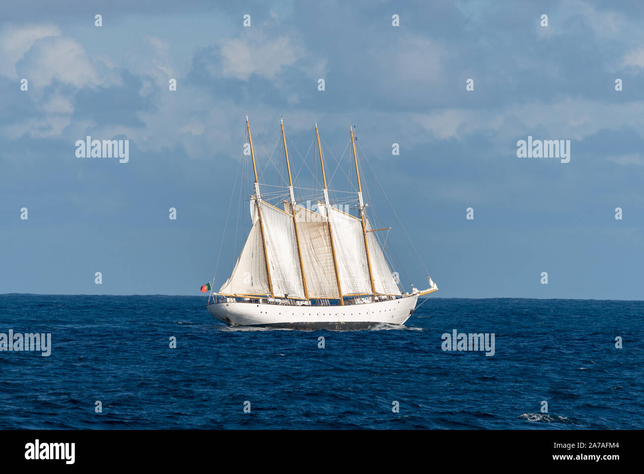 Sailing ship with four white sails Stock Photo - Alamy