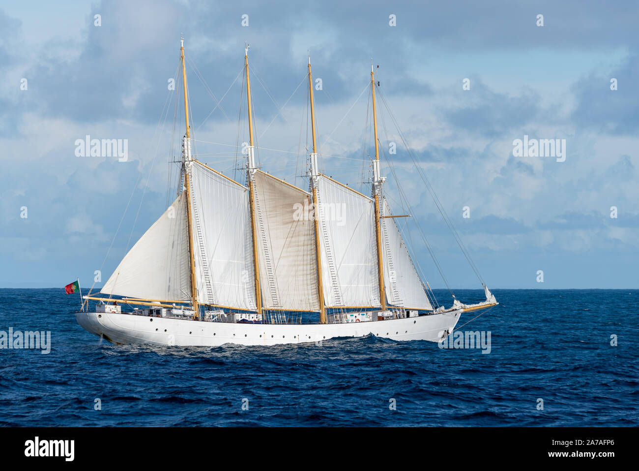 Sailing ship with four white sails Stock Photo - Alamy