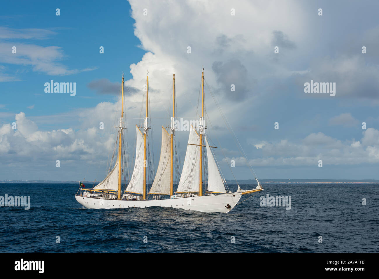 Sailing ship with four white sails Stock Photo - Alamy