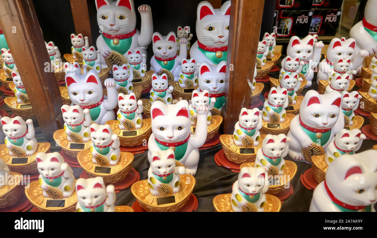 beckoning cat figurines in a store window of chinatown in san francisco ...
