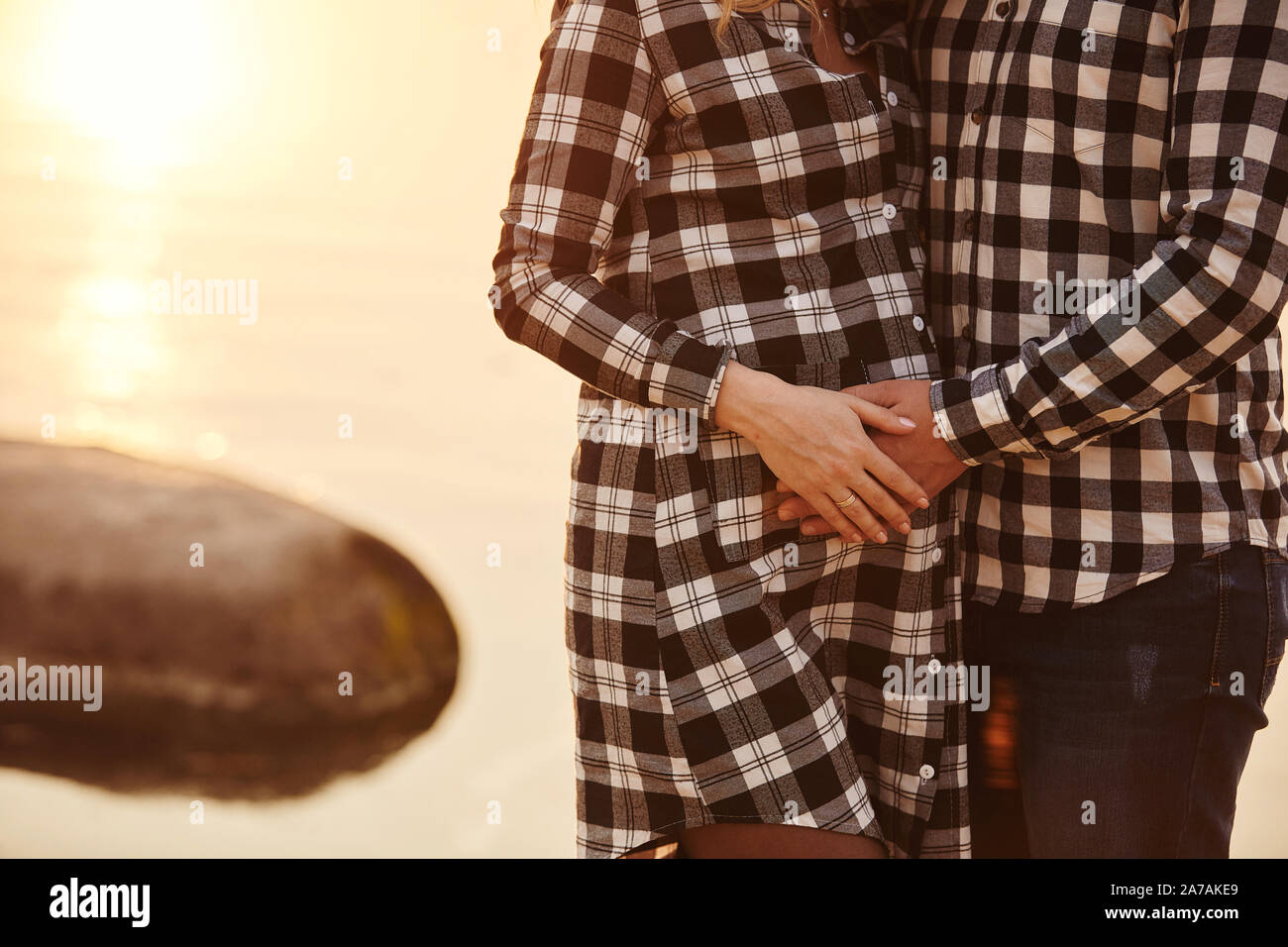 Young couple expecting baby hugging stomach. pregnancy and people ...