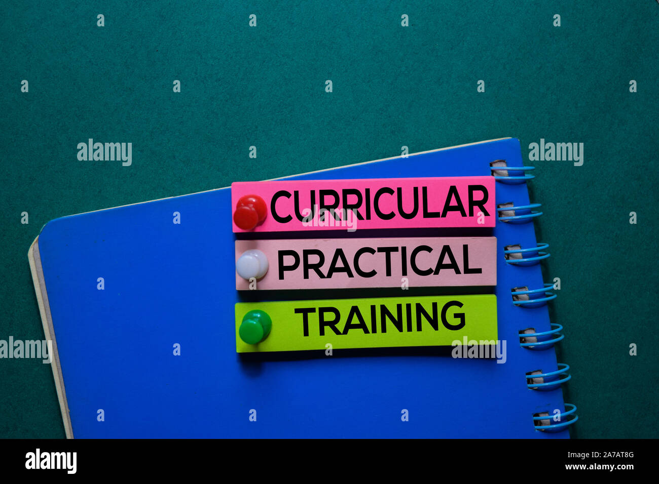 Curricular Practical Training text on sticky notes. Office desk ...