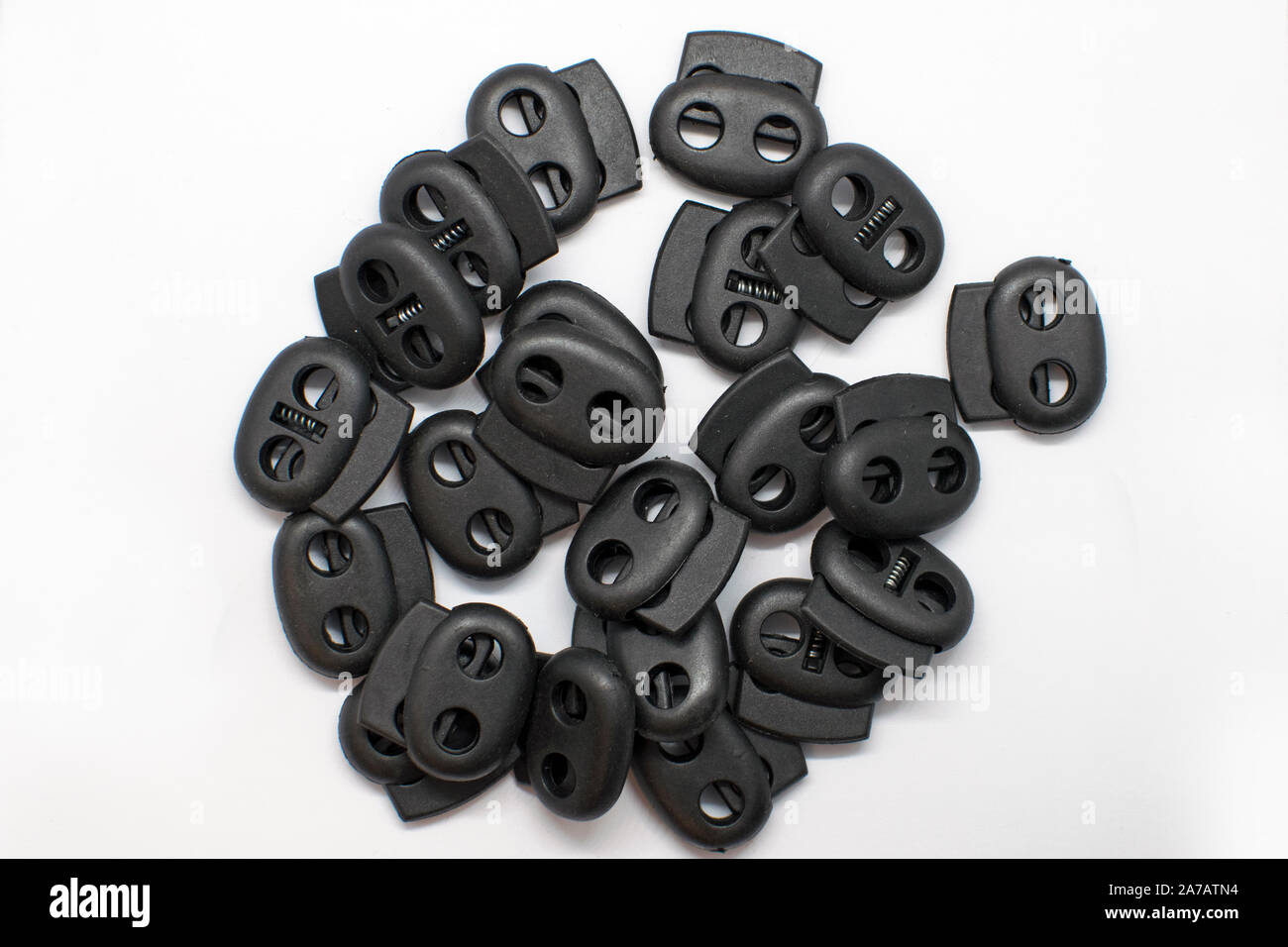 Catch clips for adjusting length and volume. Two-hole plastic retainer ...