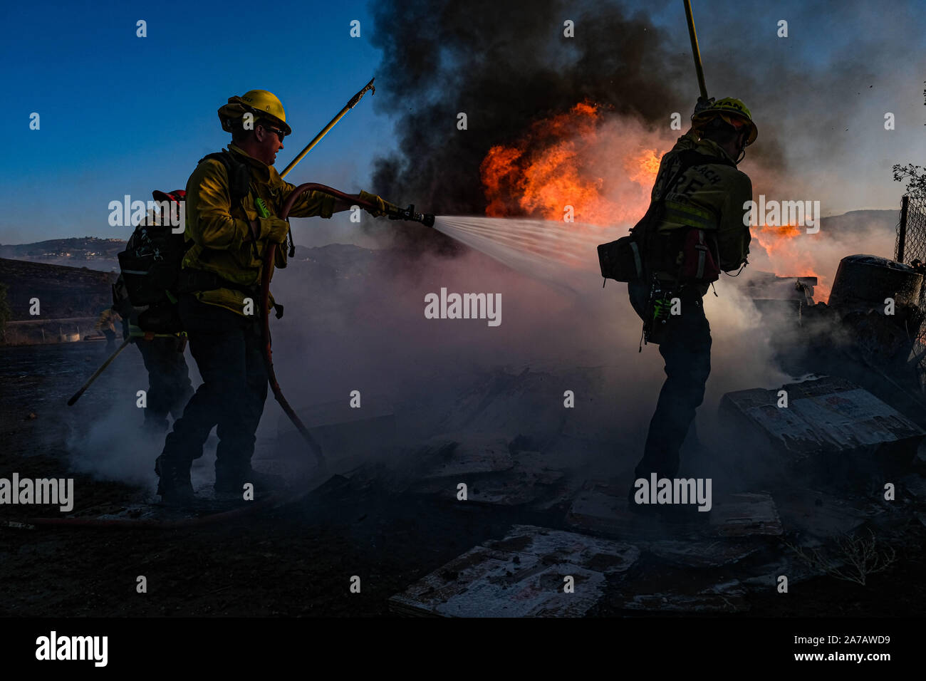 Simi Valley, California, USA. 30th Oct, 2019. Firefighters extinguish ...
