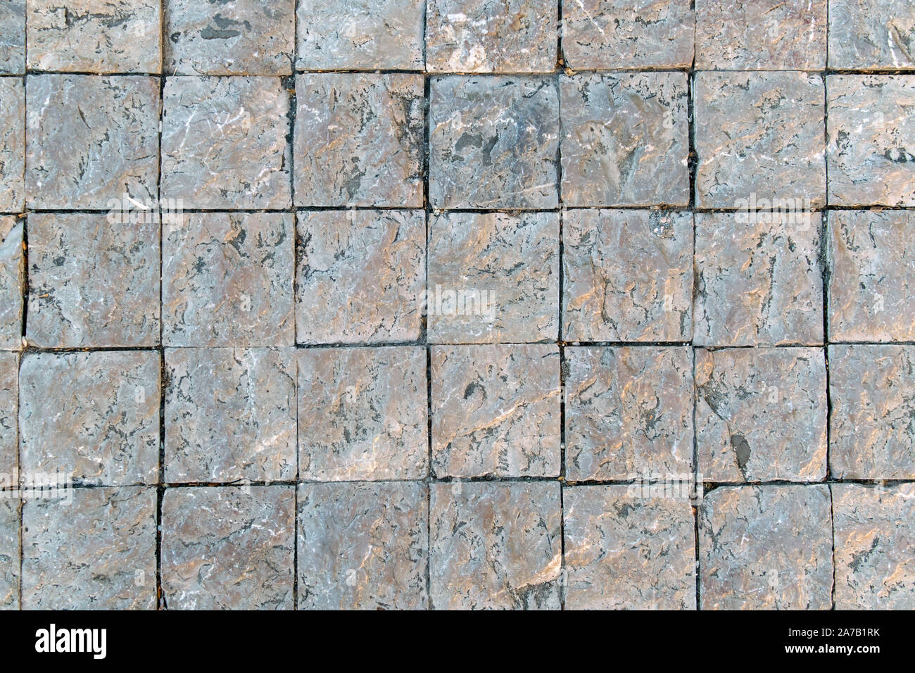 Granite cobblestoned pavement background. Fragment of a pavement along ...
