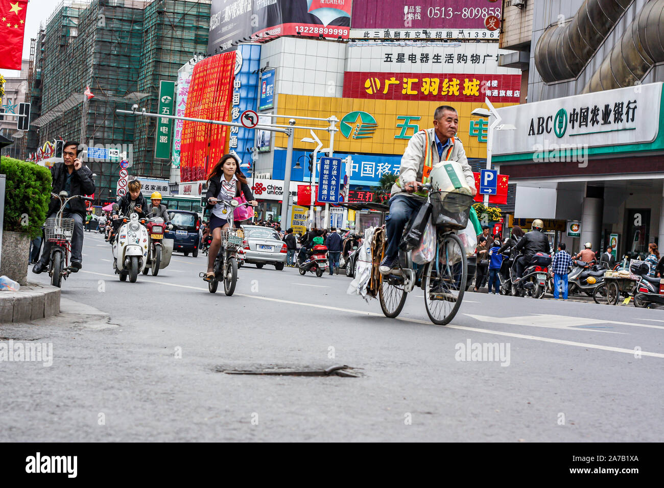 Asian Chinese cyclists and motor riders, morning rush hour heavy ...