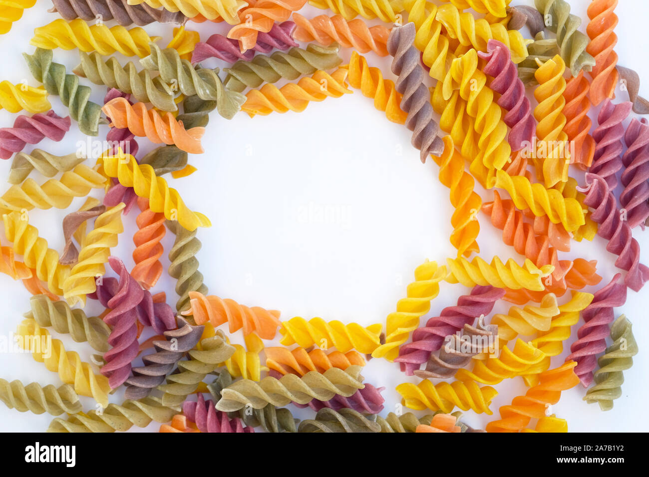 Colored pasta in the shape of a spiral. Pasta of different colors top ...