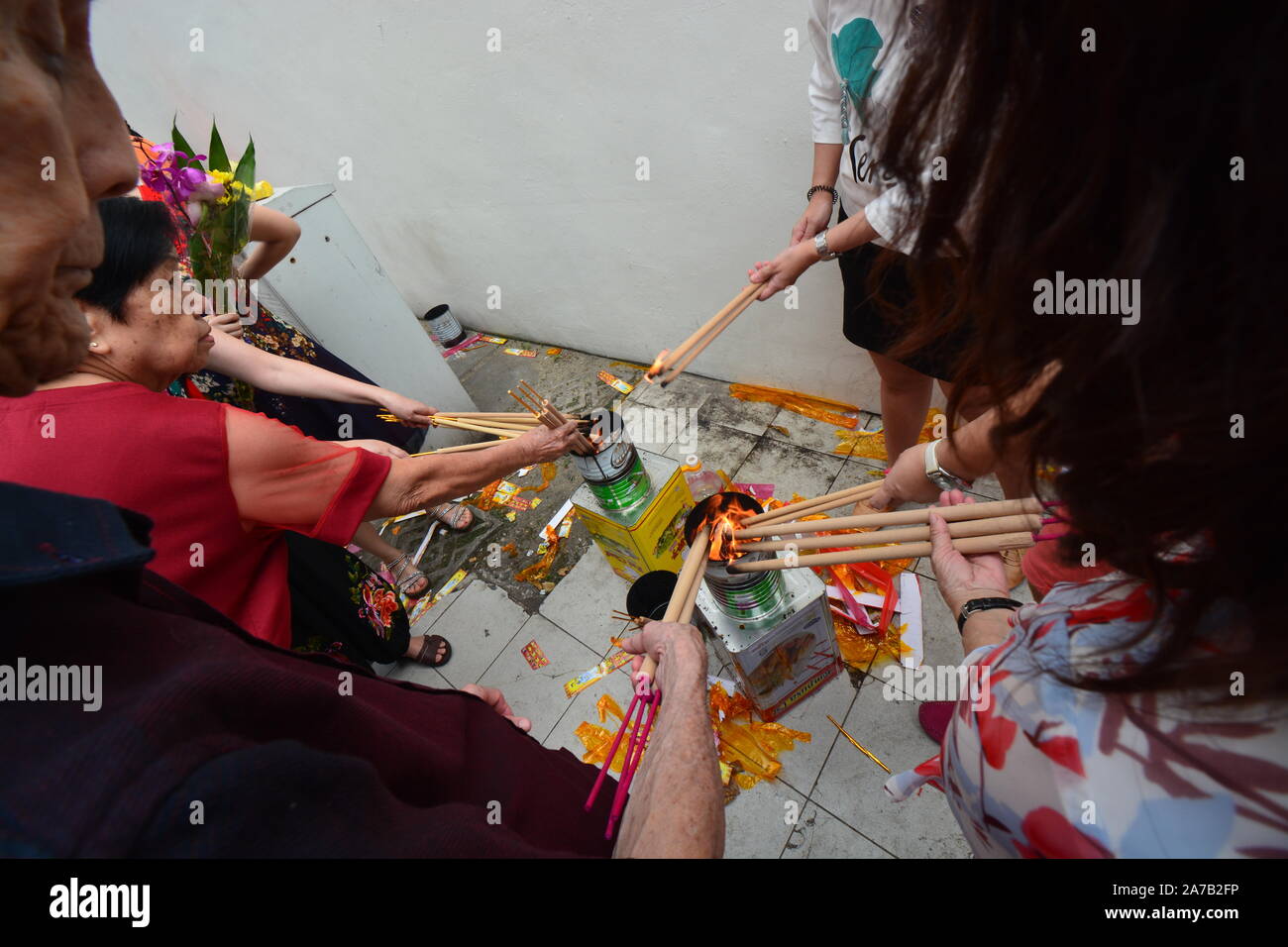 Asian people praying in Chinese temple with incense joss sticks during ...